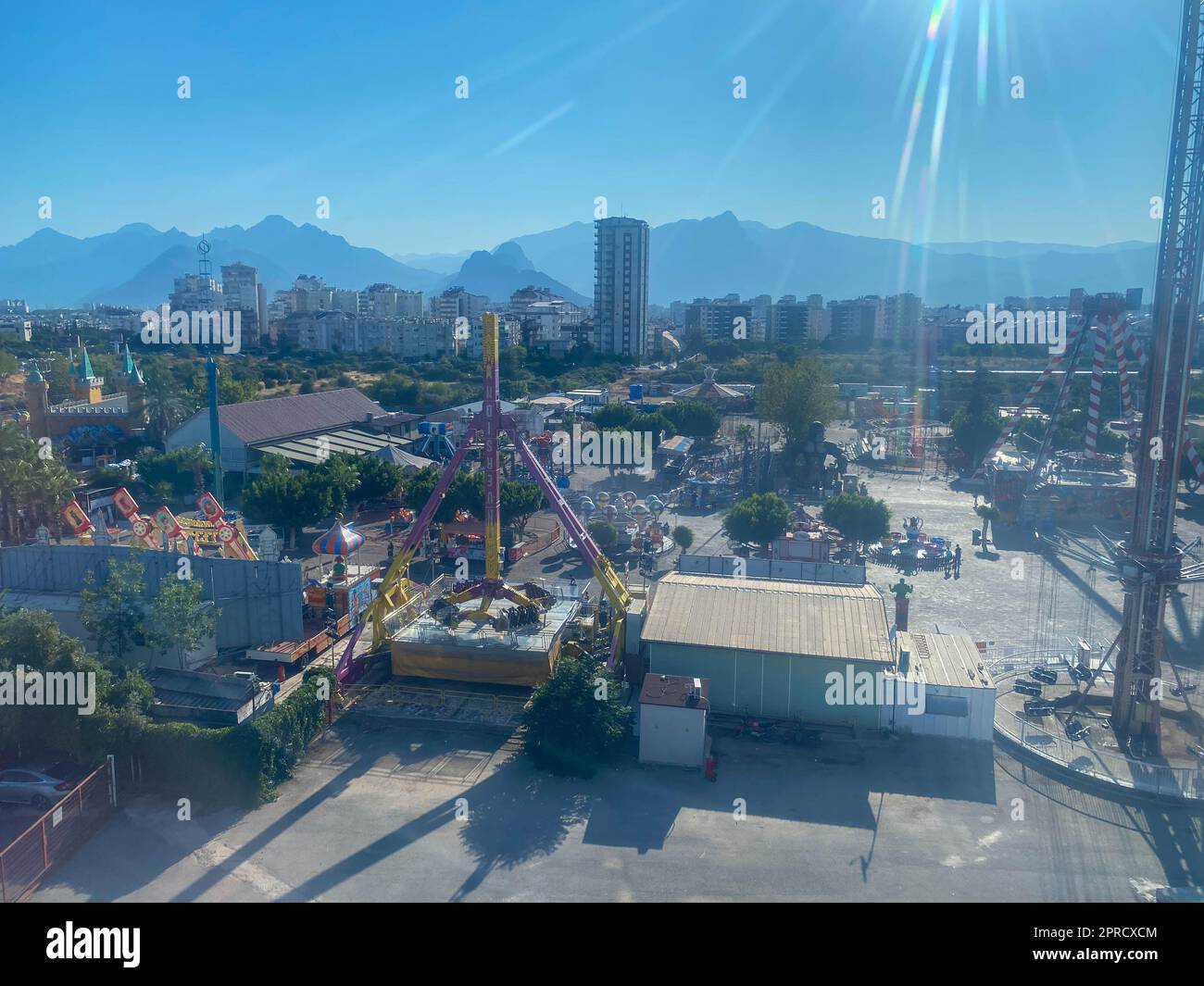 Top view of the amusement park with a ferris wheel and roller coaster ...
