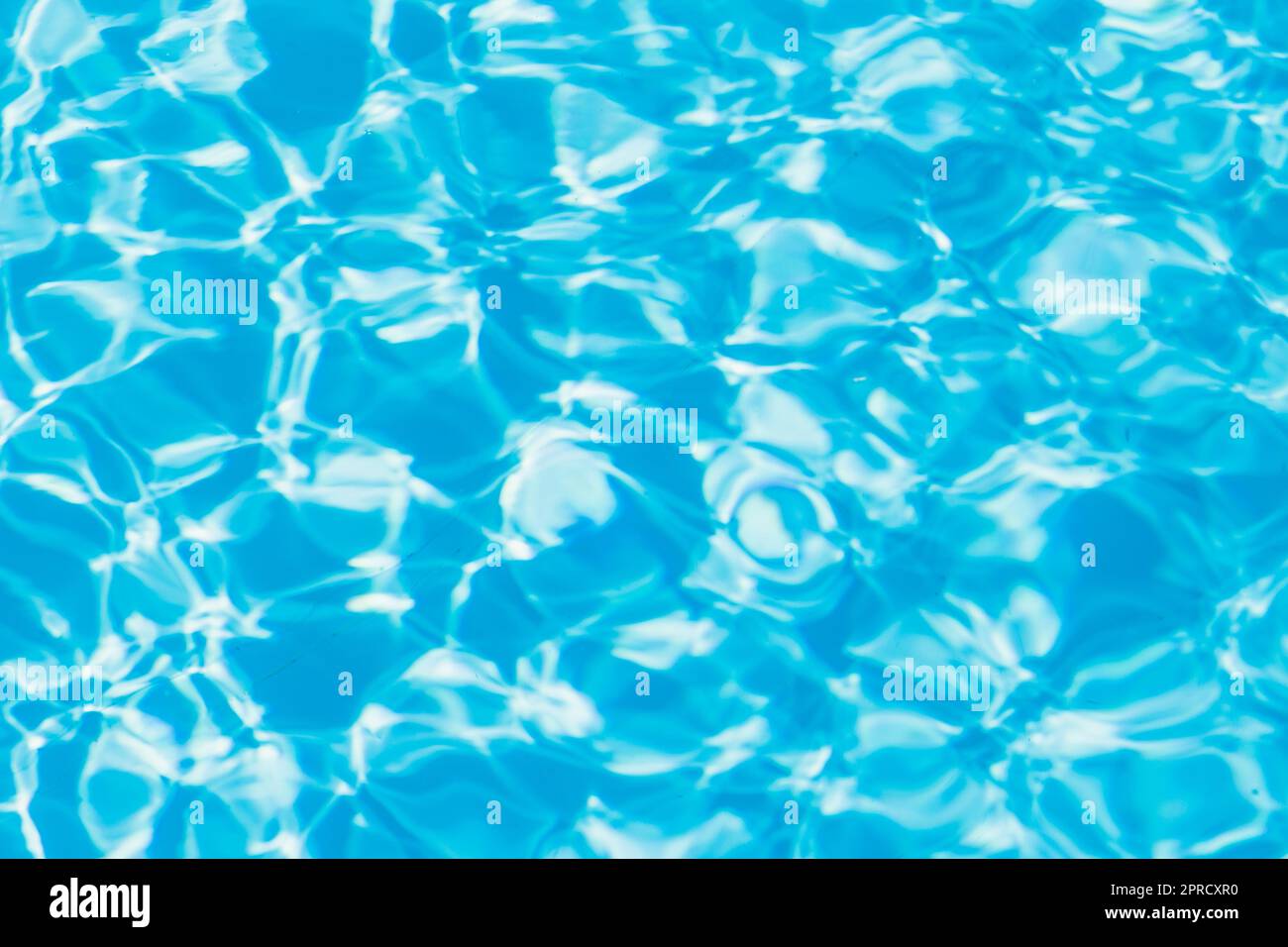 Blue pool water with sun reflections background Stock Photo - Alamy