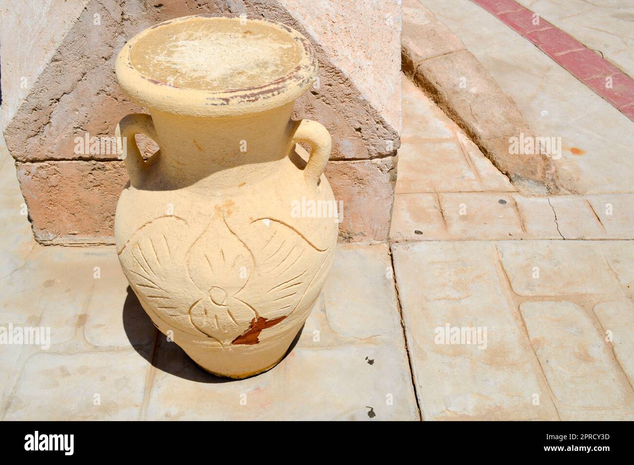 A large stone, clay-old antique vintage yellow carved heavy pitcher ...