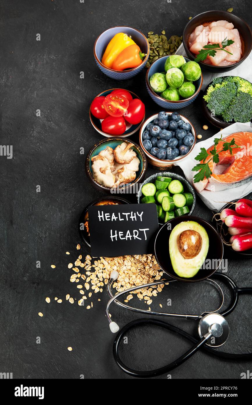 Food for a healthy heart concept and stethoscope on black background ...
