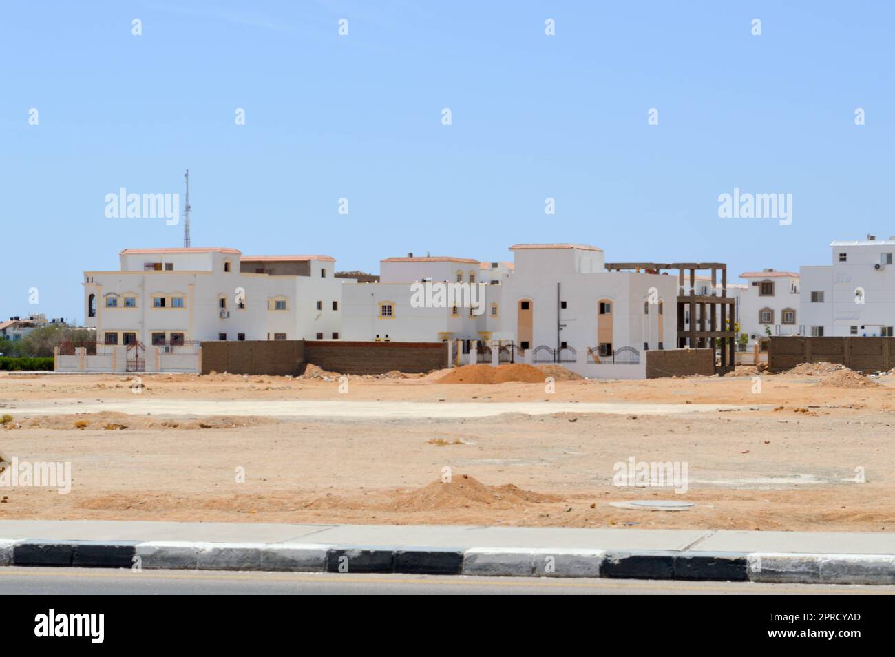 White Arabian rectangular houses in the desert with windows against the ...