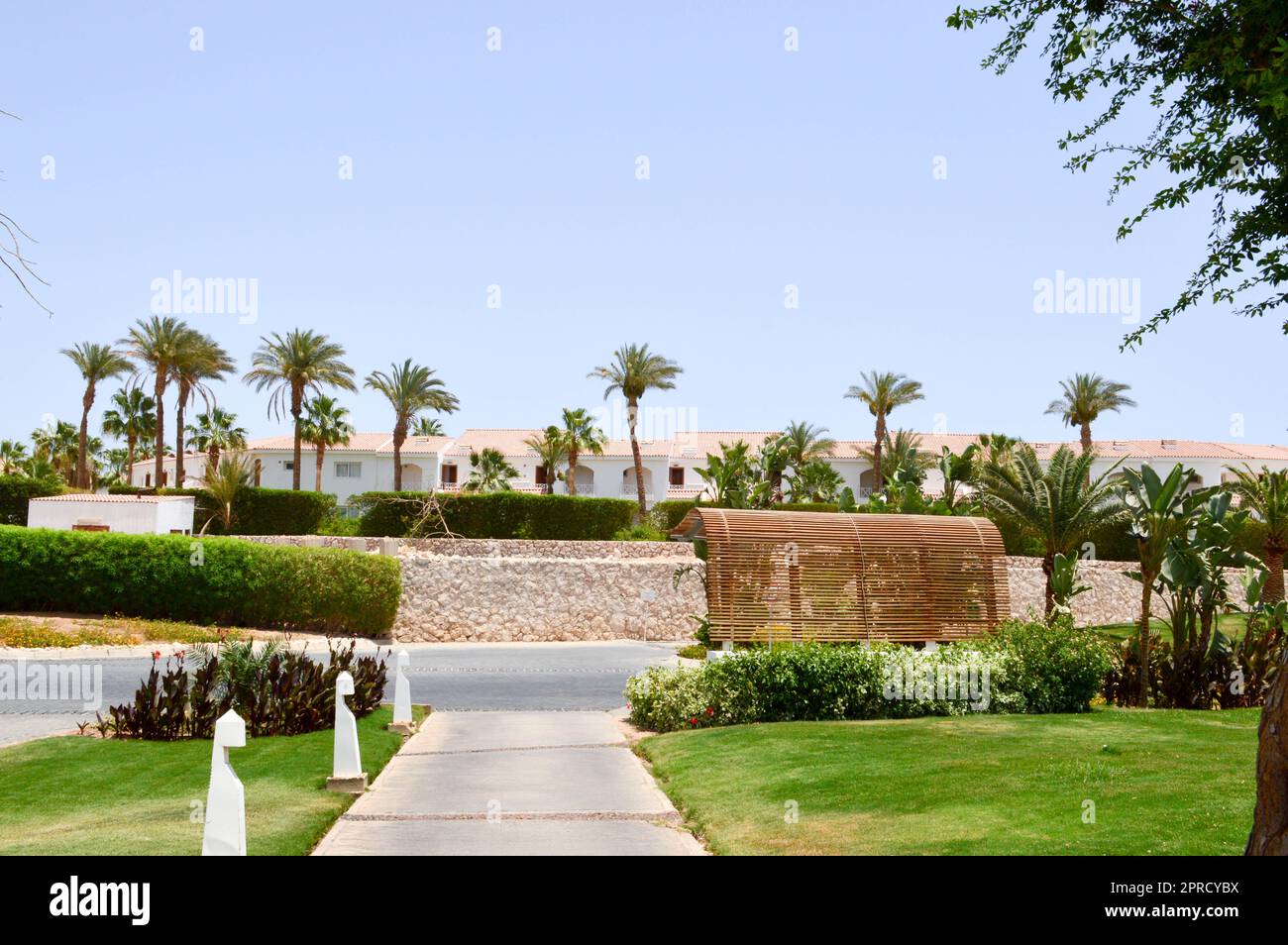 A beautiful wooden bus stop of public transport on a street in a warm ...