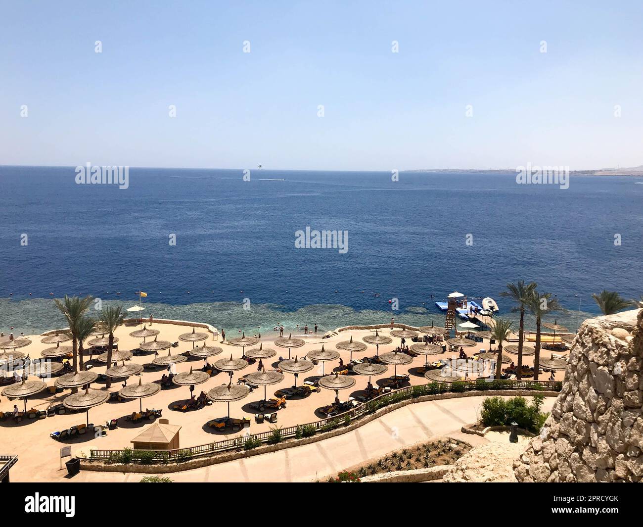 View from the top to a beautiful sandy beach with sun loungers, sun ...