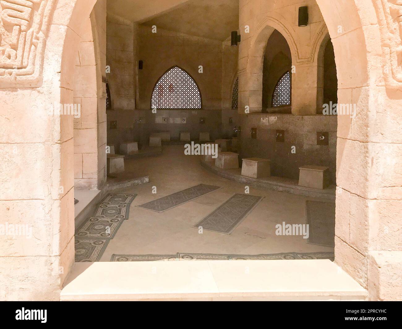 View through the arch to a place for washing with tap water in an Arab ...