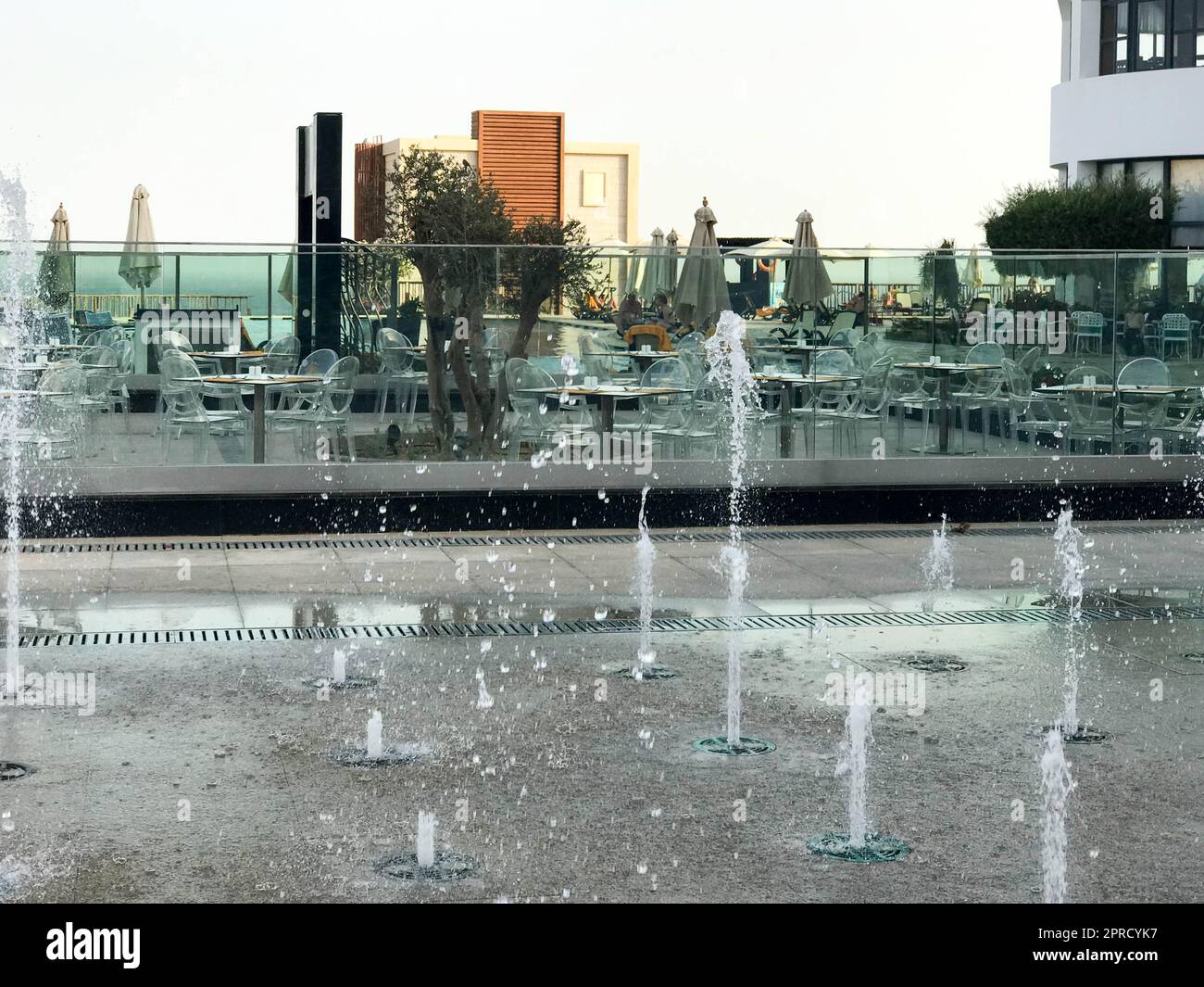 A small singing fountain in the open air, on the street. Drops of water ...