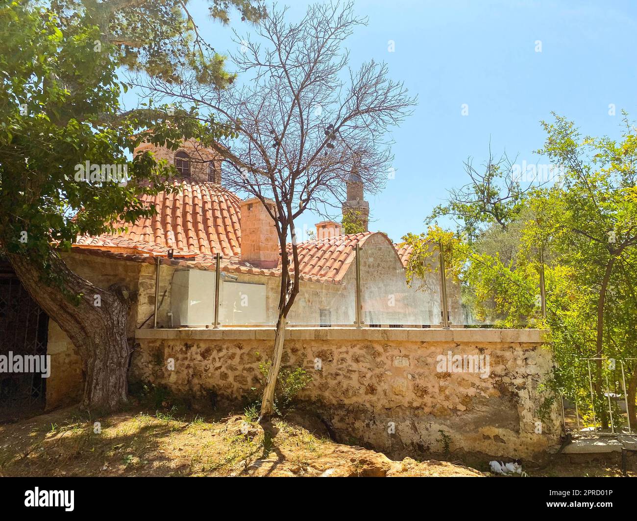 a building with white walls and a tiled roof. house with domes and ...