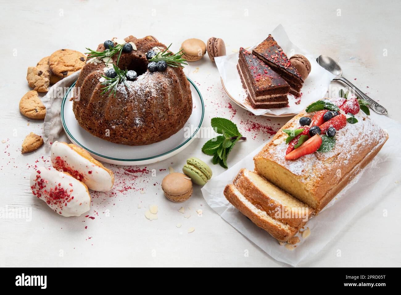 Dessert table with various of bundt cakes, pieces of cakes, sweets ...