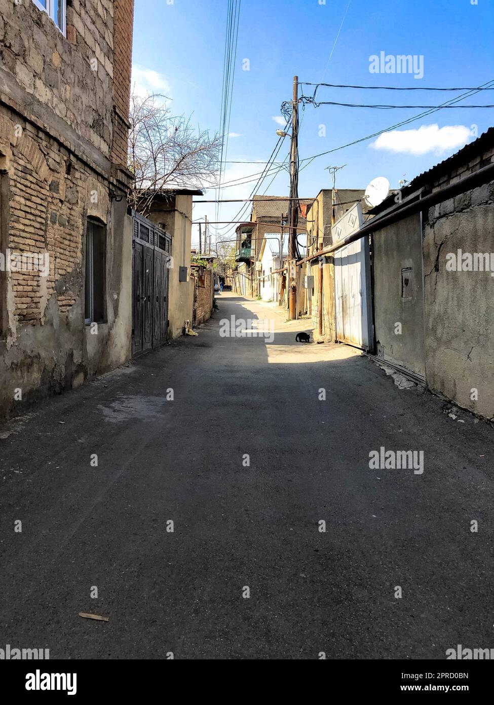 Narrow street, lane, tunnel with old houses, buildings on the sides in ...