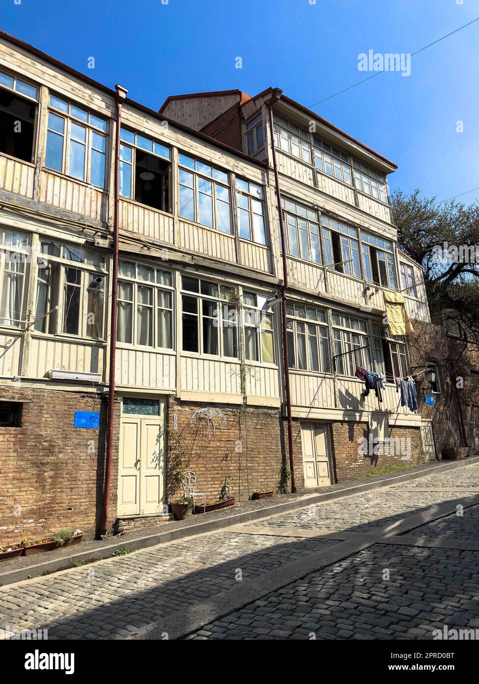 Old buildings with wooden balconies and windows on the road with a ...