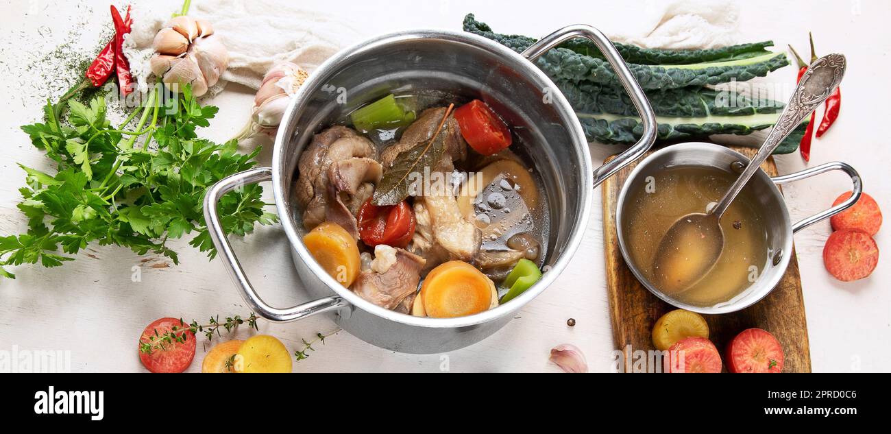 Beef broth of beef meat on bones slow cooked with vegetables: carrot ...
