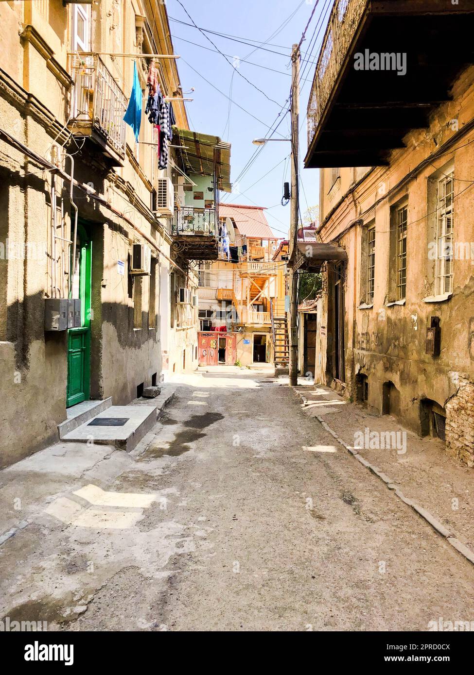 Narrow street, lane, tunnel with old houses, buildings on the sides in ...