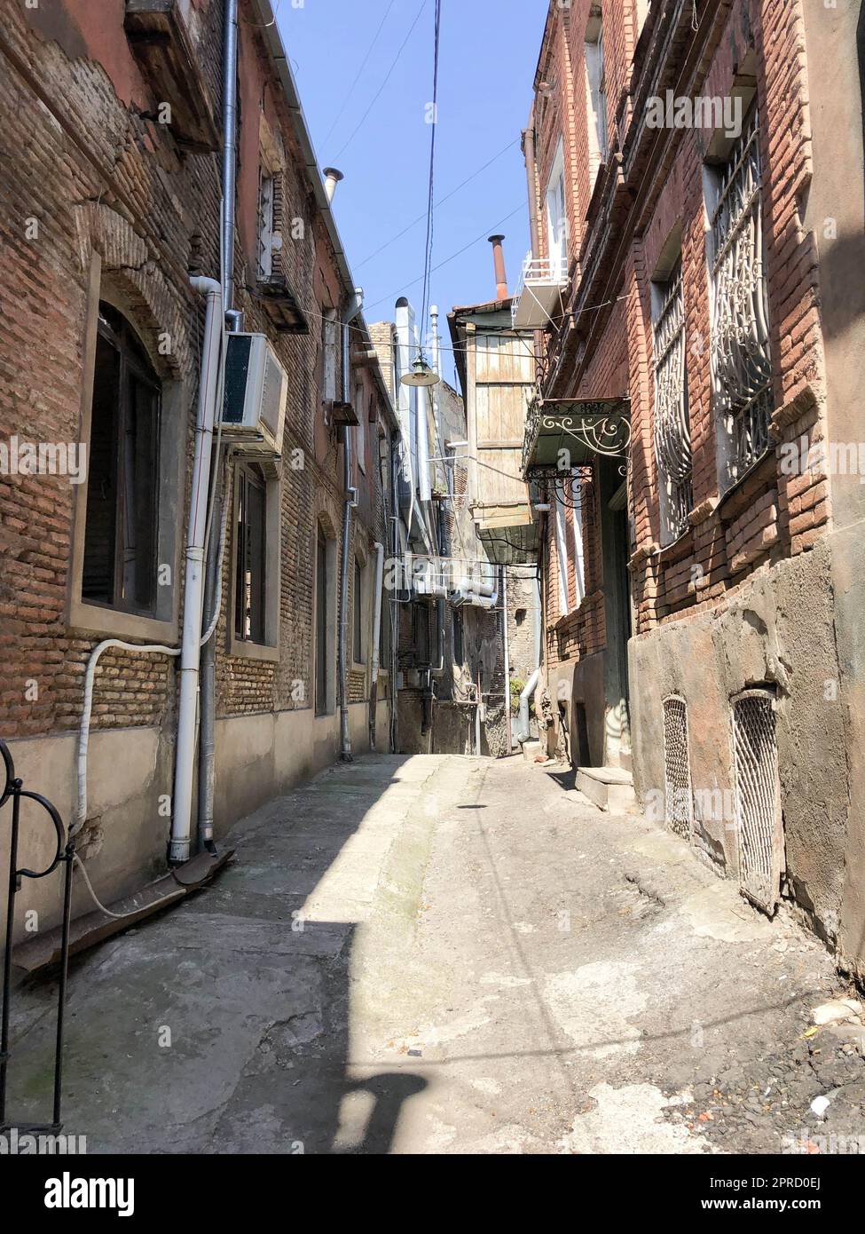 Narrow street, lane, tunnel with old houses, buildings on the sides in ...