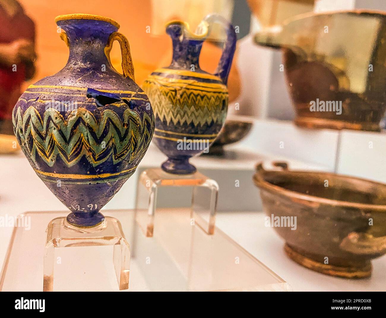two decorative jugs of blue color with a pattern. nearby are brown clay ...