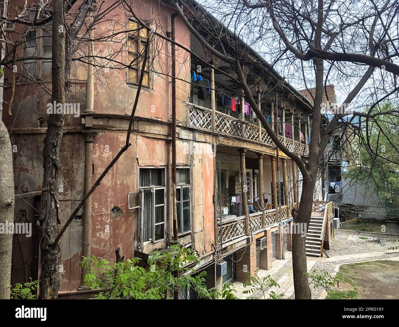 Beautiful old brown dilapidated three-story house with windows and ...