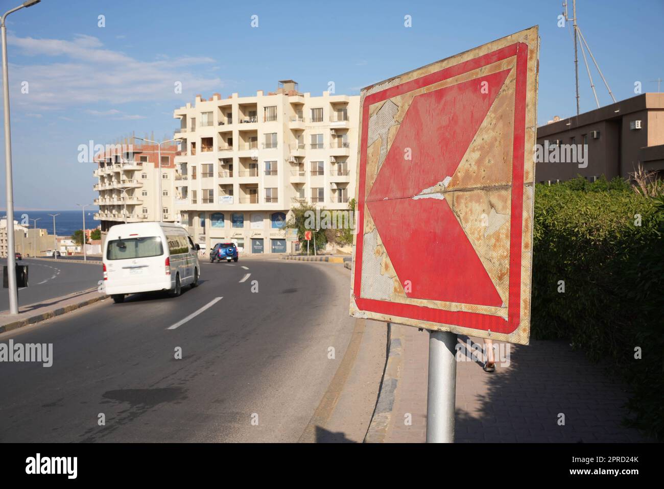 A road turn with a big red sign in Egypt Stock Photo - Alamy