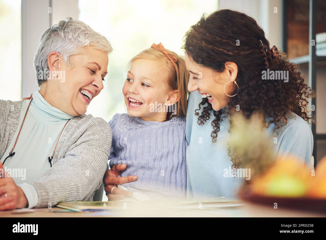 Grandmother, girl and mother laughing in home, playing and bonding ...