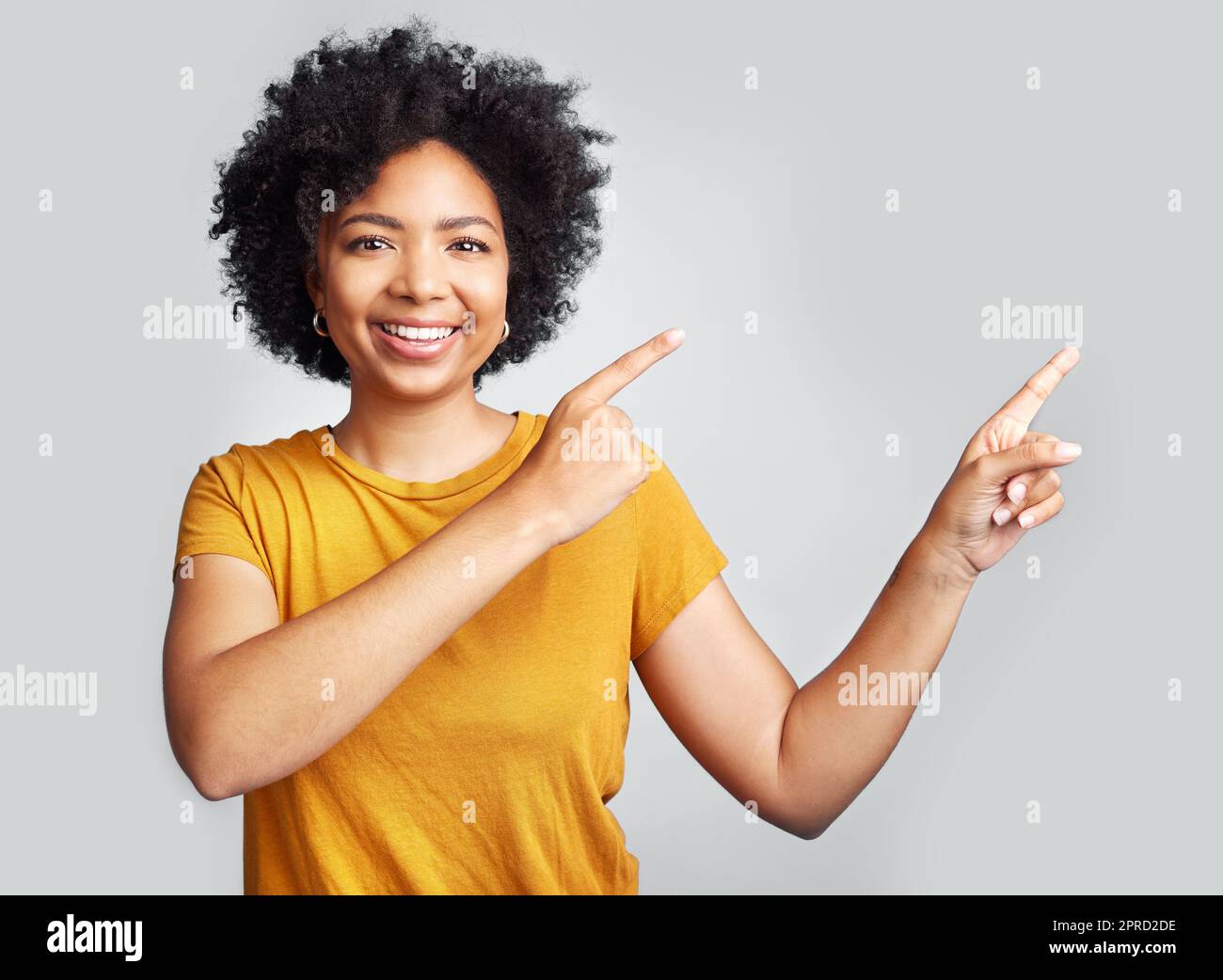 Happy woman, portrait and pointing to advertising at white background ...