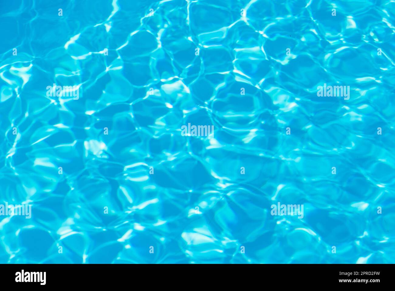 Blue pool water with sun reflections background Stock Photo - Alamy