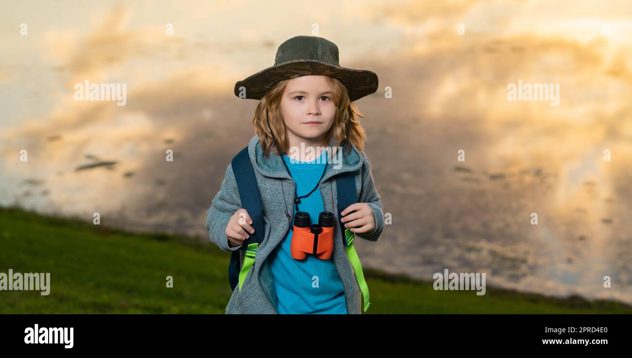 Childhood. Scout boy wearing explorer hat and backpack outdoor ...