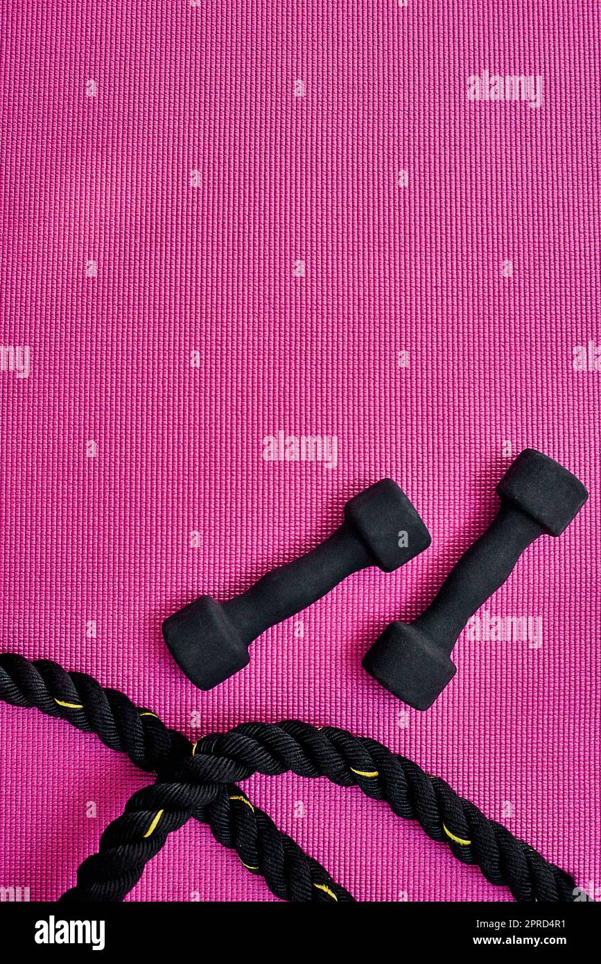 Who wants to get fit. High angle shot of two lightweight dumbbells and ...