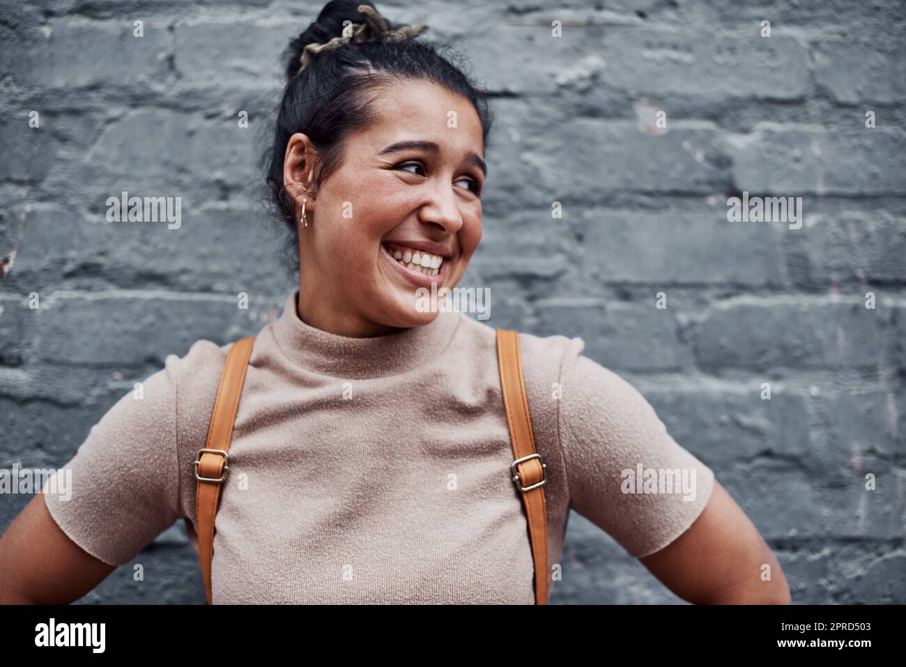 All smiles here. an attractive teenage girl standing alone against a ...