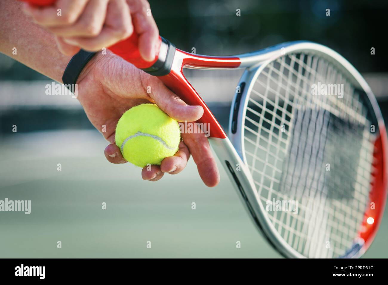 Ready to serve. an unrecognizable sportsman holding a tennis ball and ...