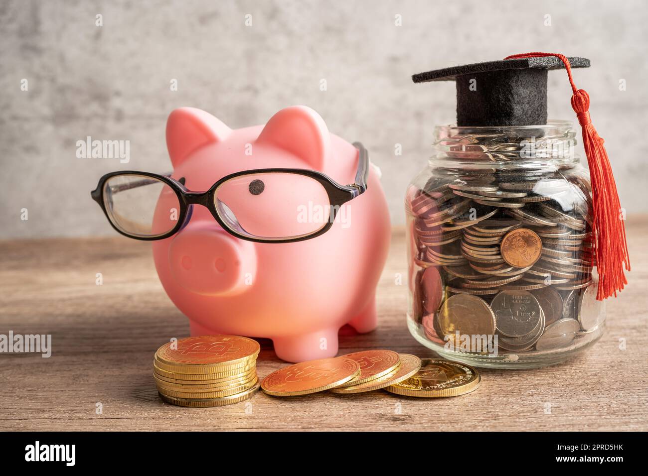 Pigging bank wearing eyeglass with coins and graduation hat saving bank ...