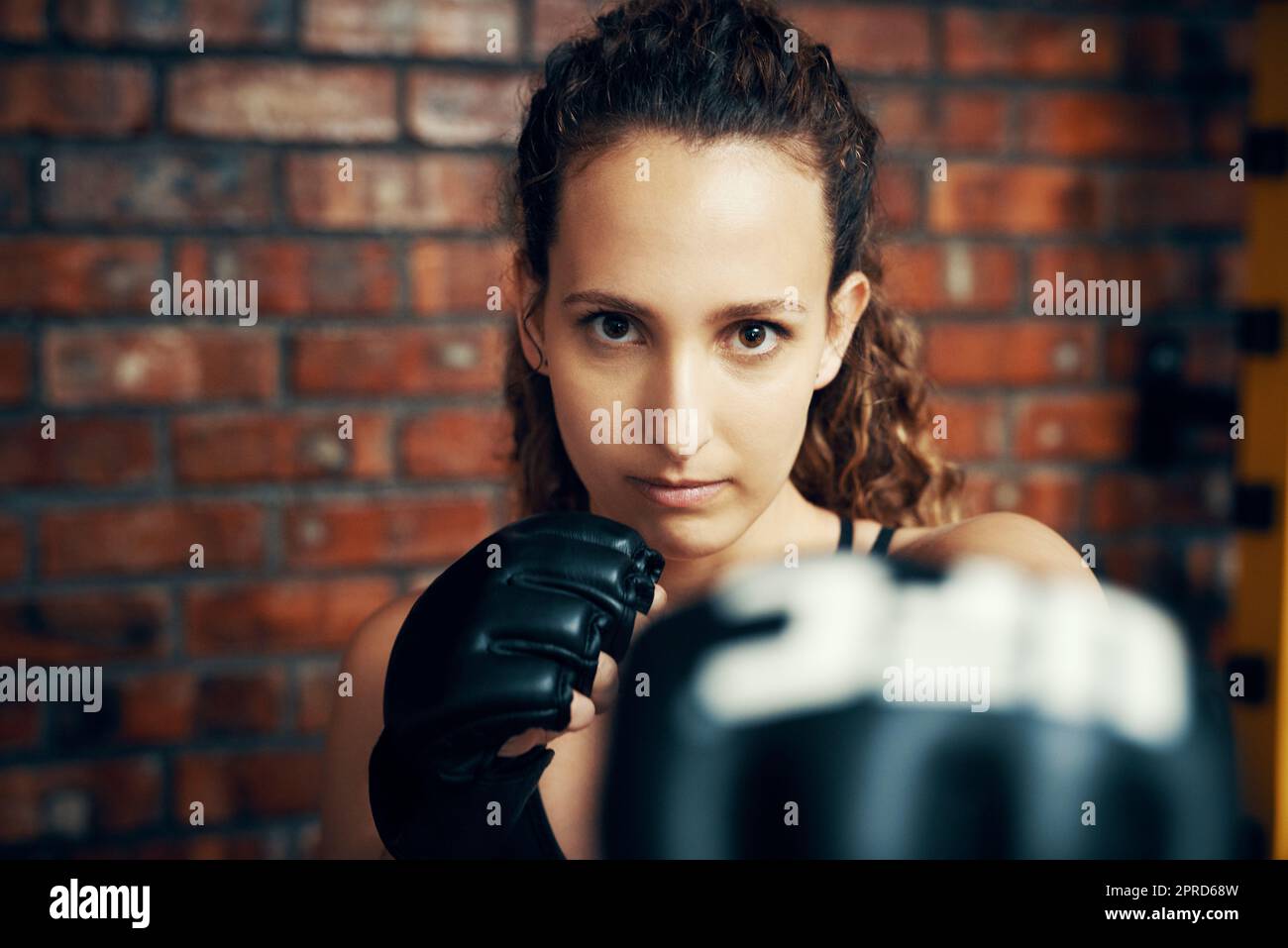 Ill kick some butt if I have to. Cropped portrait of a female kick ...