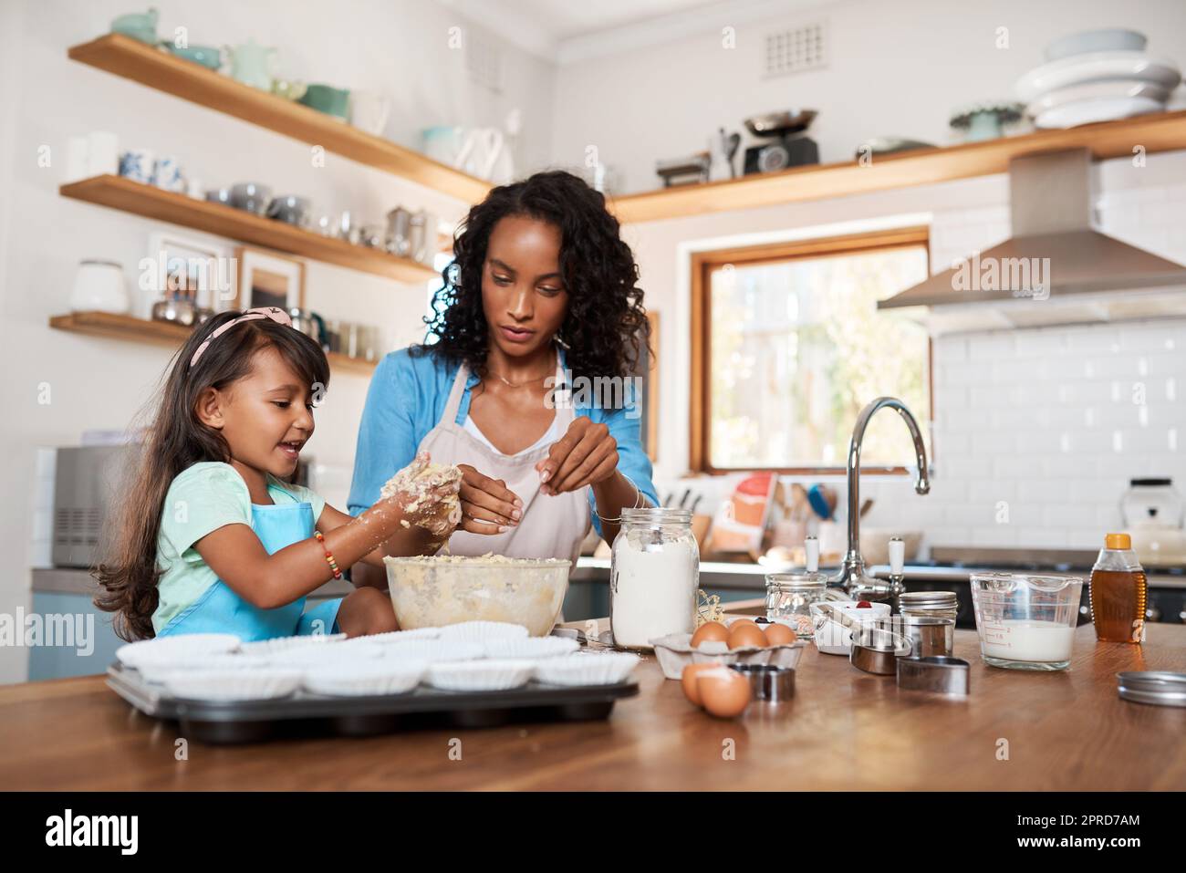 Baking is fun and oh so rewarding. a woman baking at home with her ...