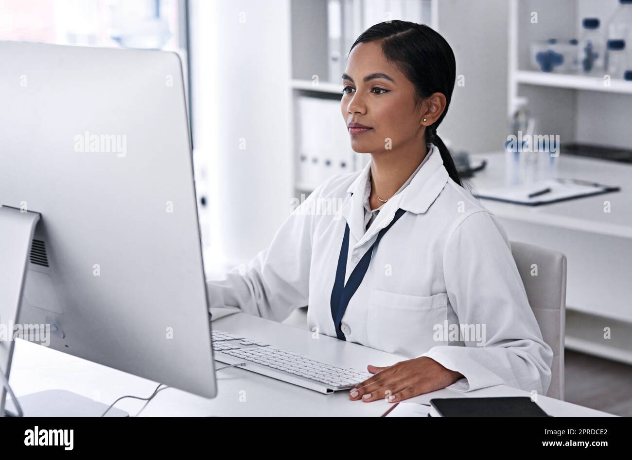 Science is hard work. an attractive young female scientist working on ...