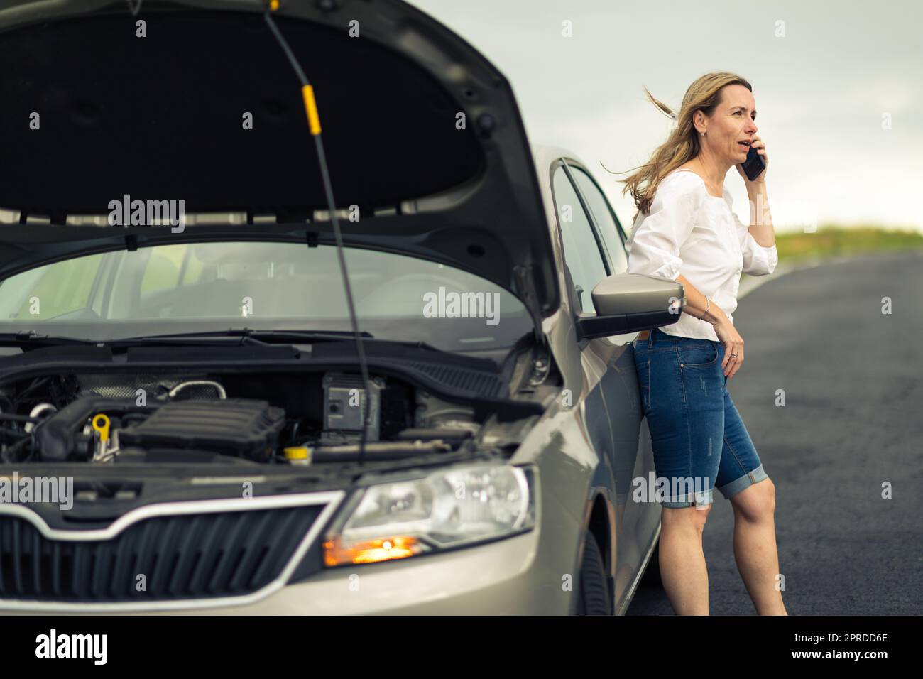 Pretty middle aged woman having car troubles - broken down car on the ...