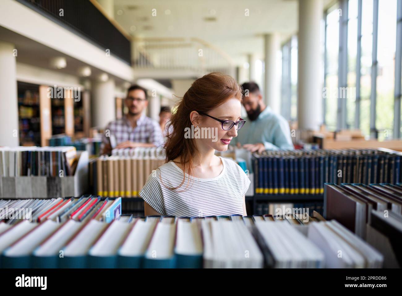 Happy group of students studying and working together in a college ...