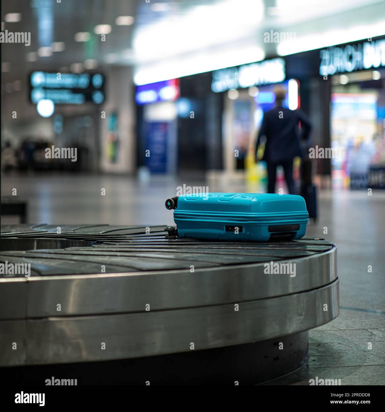 People at an international airport, at the baggage claim zone - motion ...
