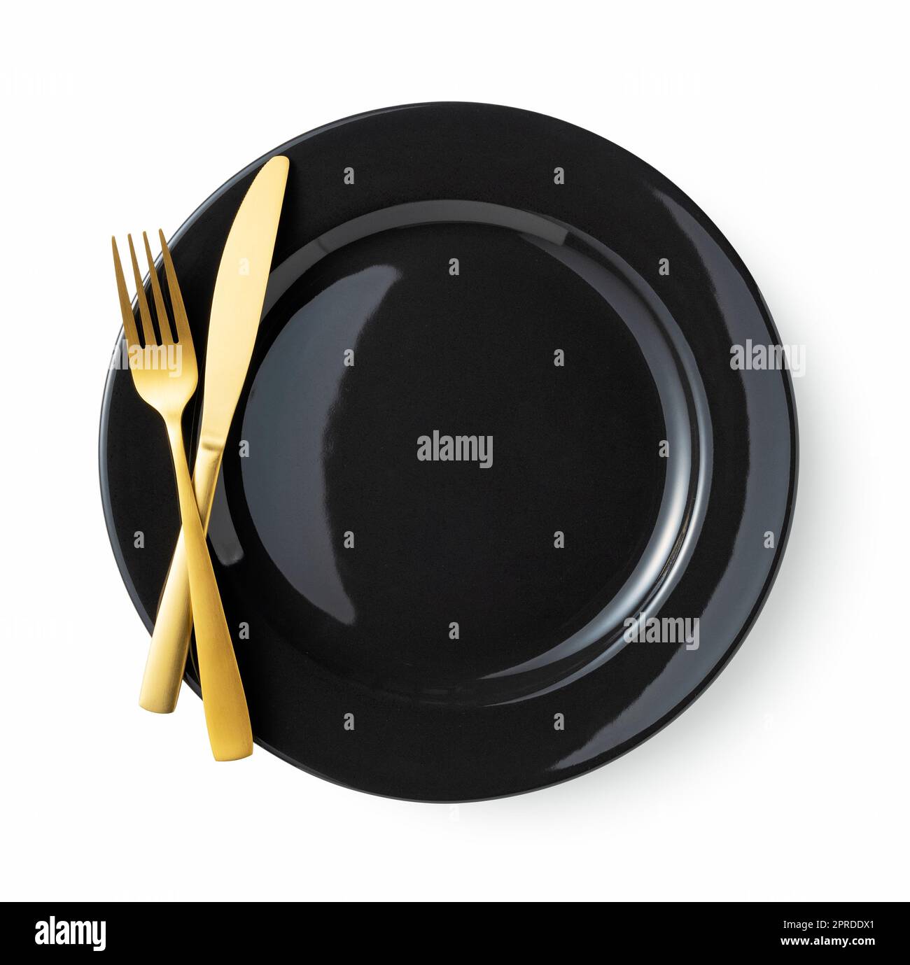 Gold knives and forks on a white background, empty black plate ...