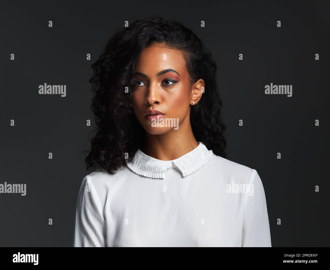 Confident and proud. Studio shot of an attractive young woman wearing a ...