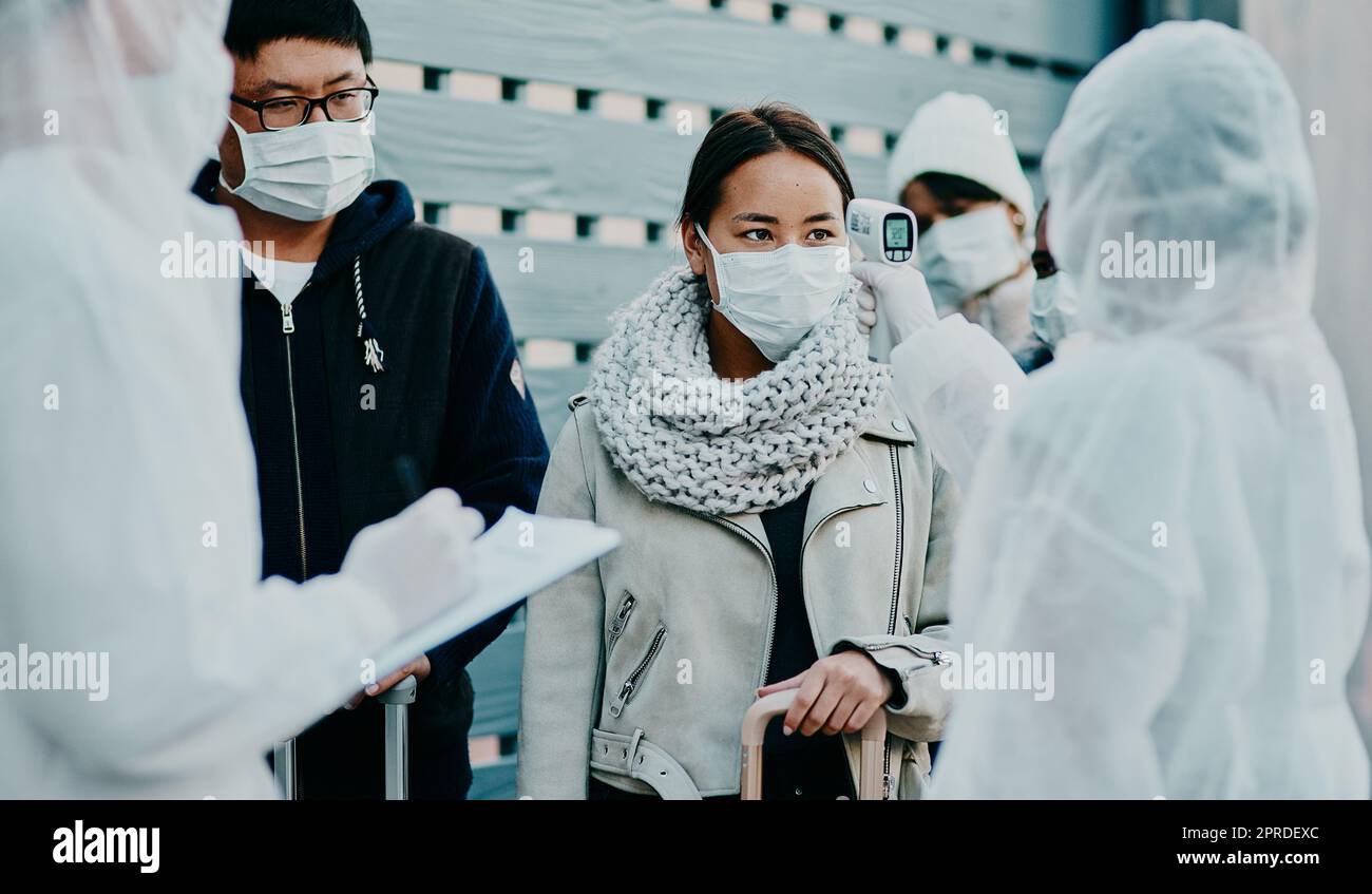 Traveling woman getting a covid temperature scan at the border with ...