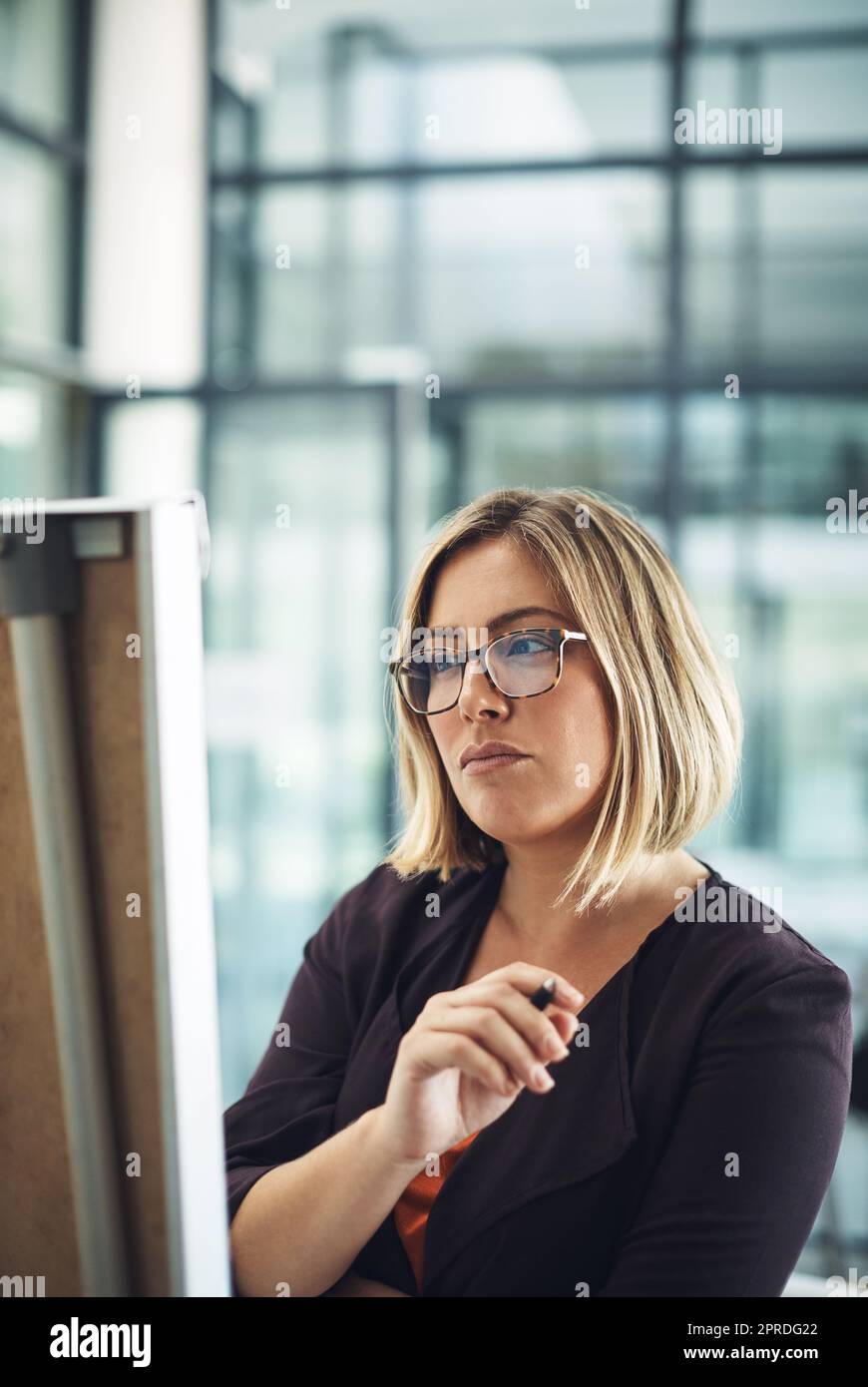 Businesswoman thinking, planning and brainstorming while looking ...