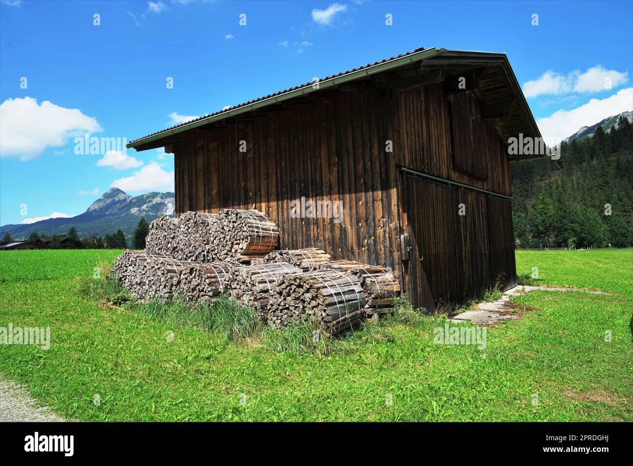 Wooden shed on a meadow under a blue sky Stock Photo - Alamy