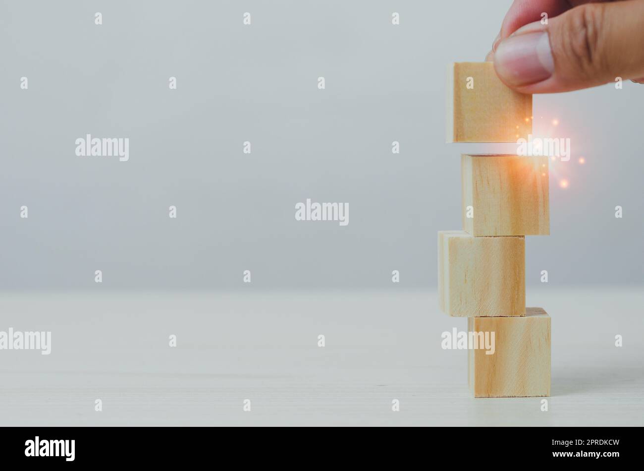 Hand wood block stacking on a table. Business growth Choose a business ...