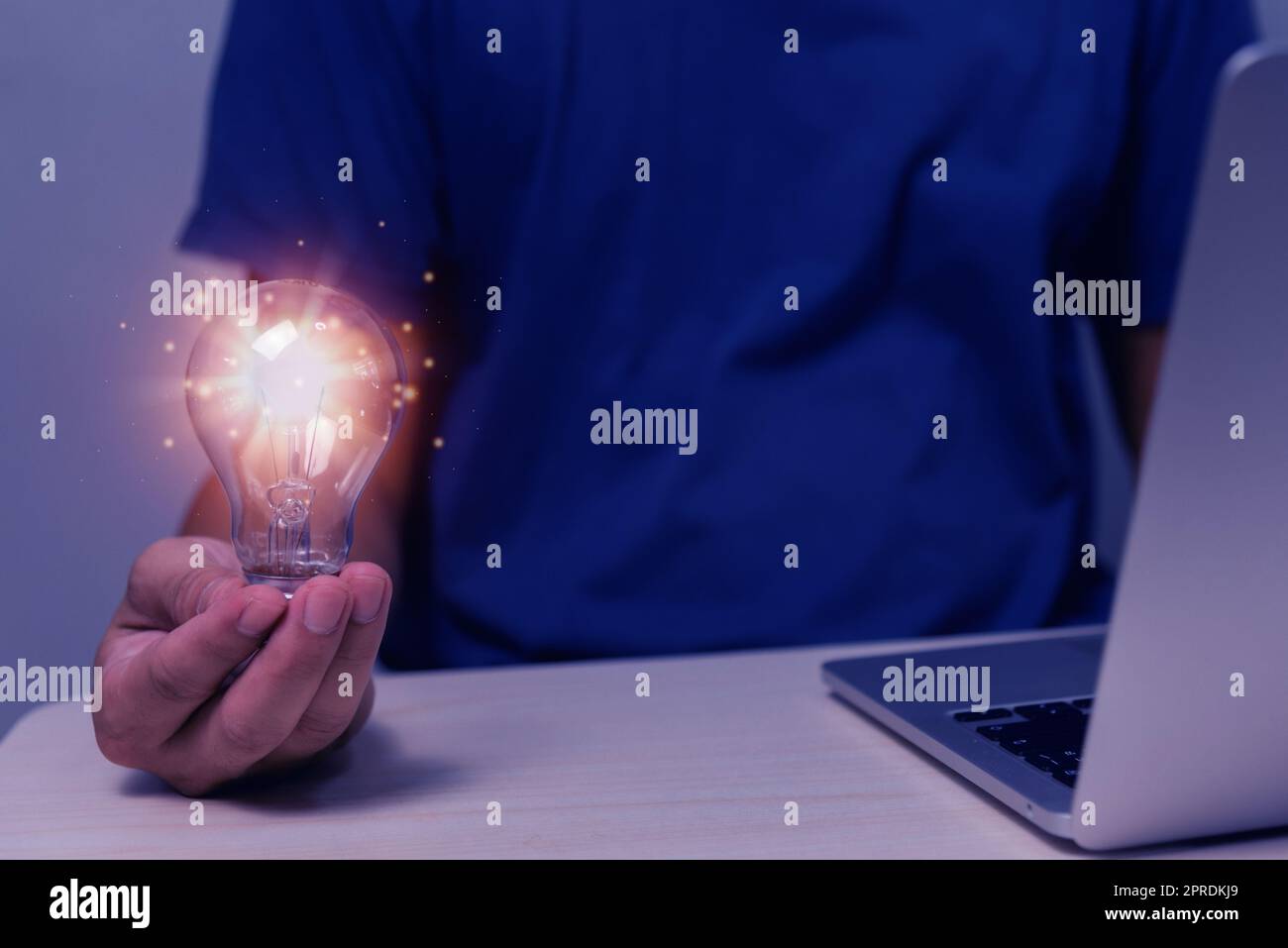 hand hold light bulb and computer on desk.Business innovation Inspiration and Creativity ...