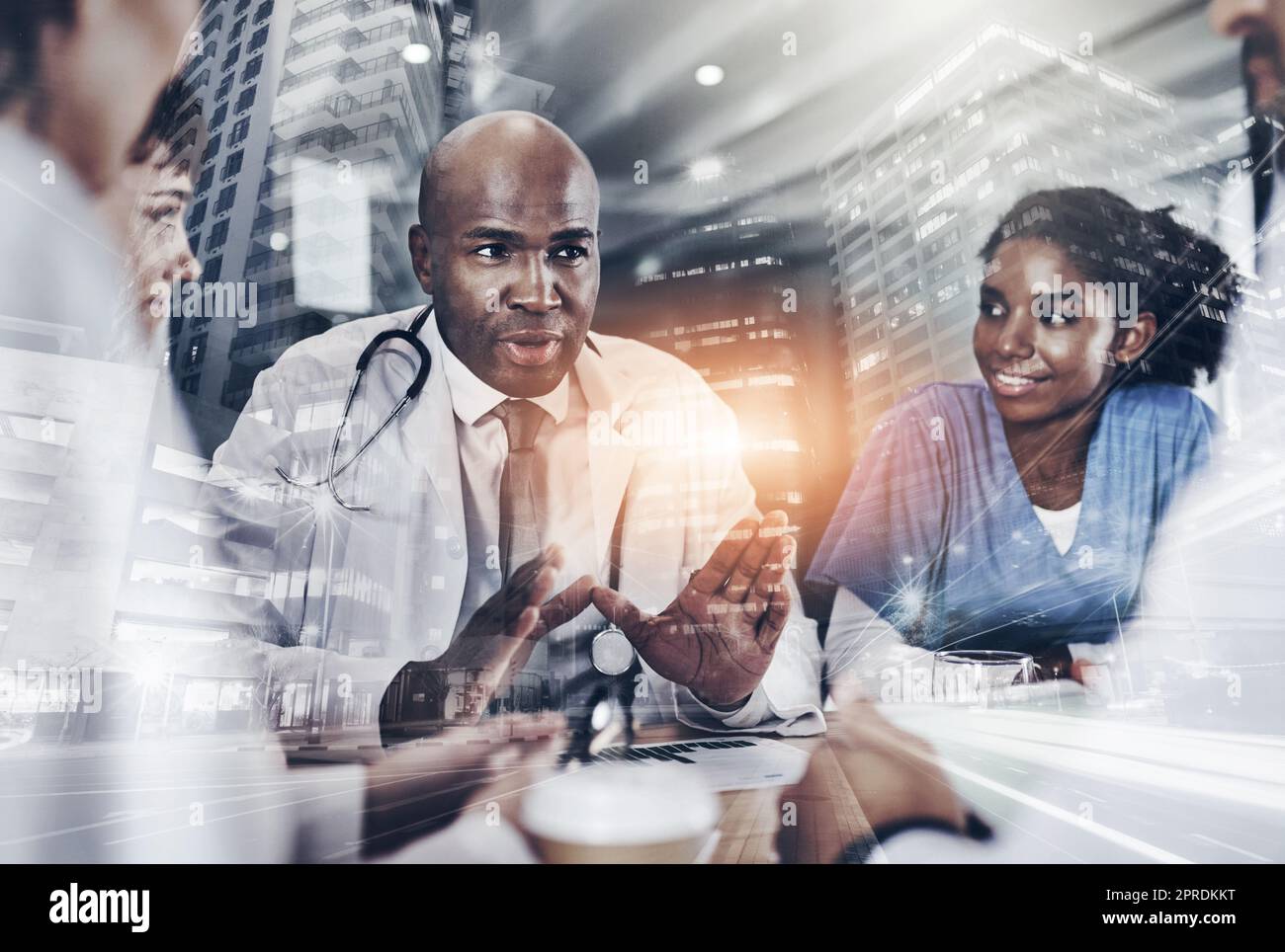 Going through a medical plan of action. a group of doctors having a ...