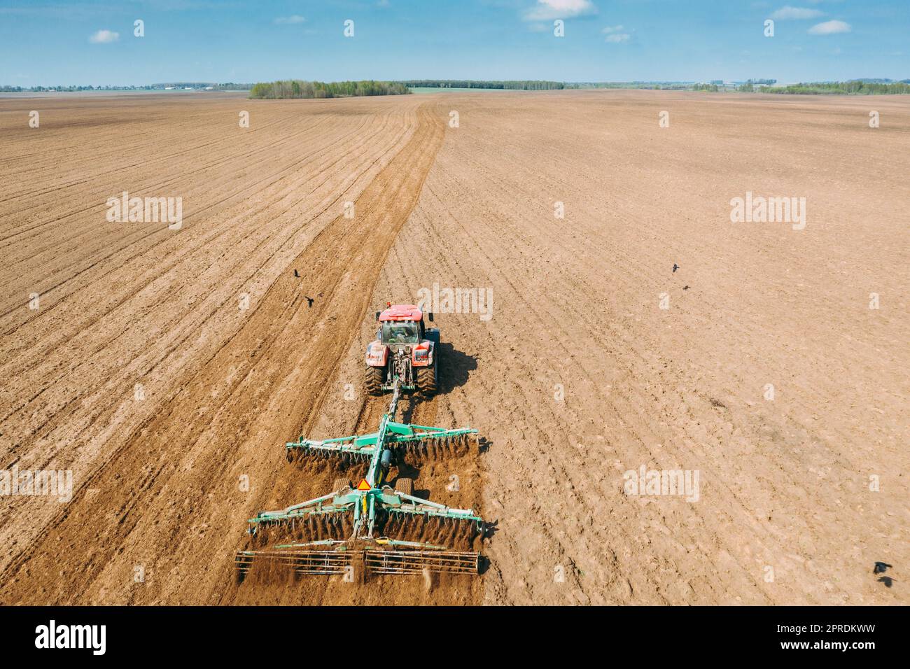 Aerial View. Tractor Plowing Field In Spring Season. Beginning Of ...