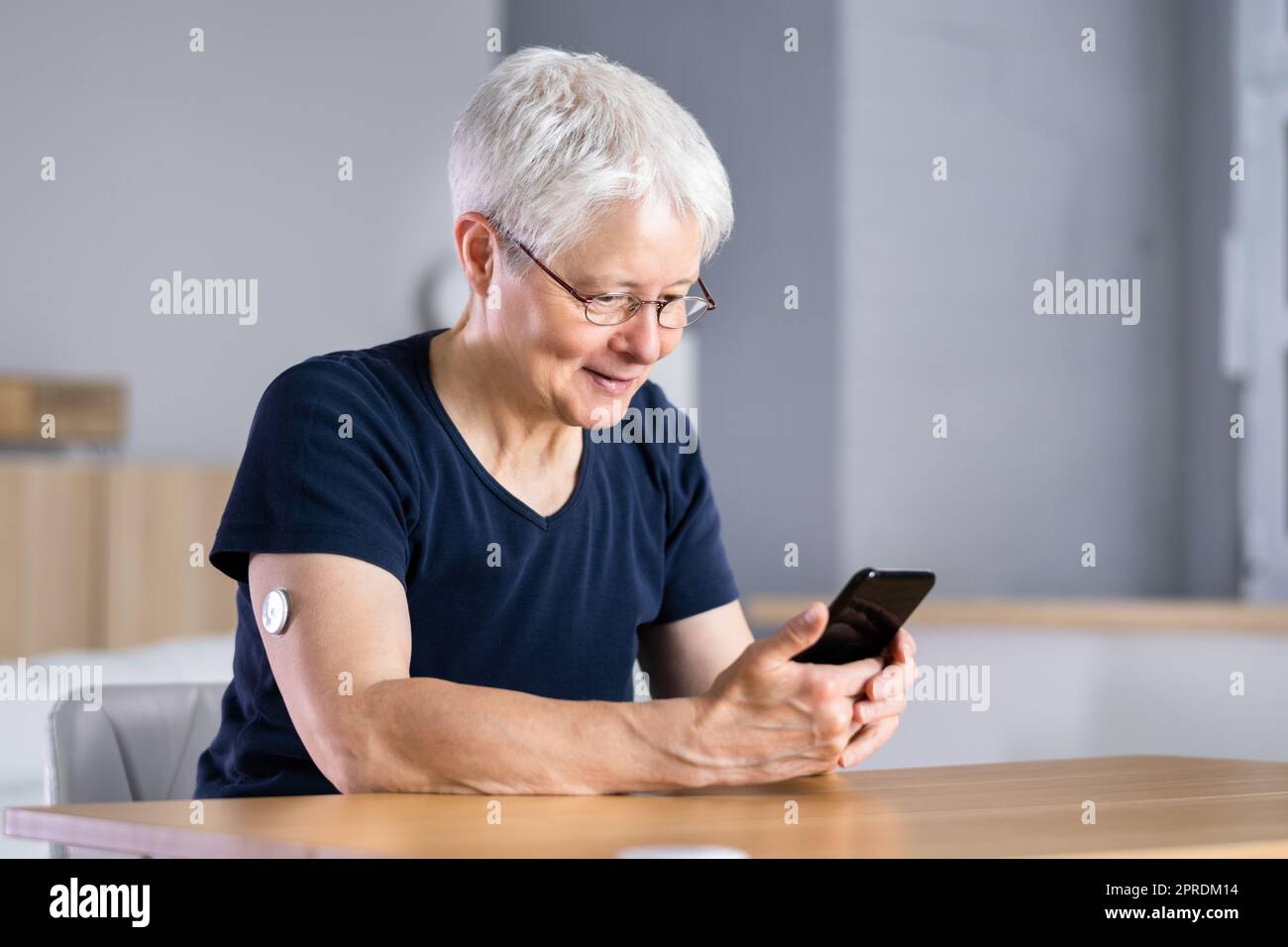 Woman Testing Glucose Level With Continuous Glucose Monitor Stock Photo ...
