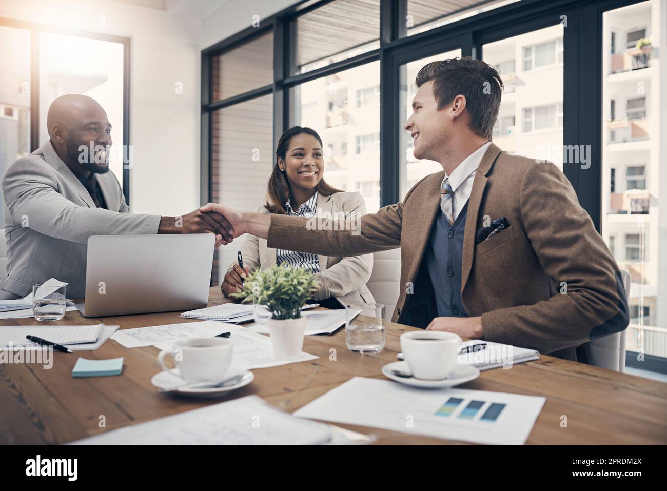The masters in negotiation. young businessmen shaking hands during a ...