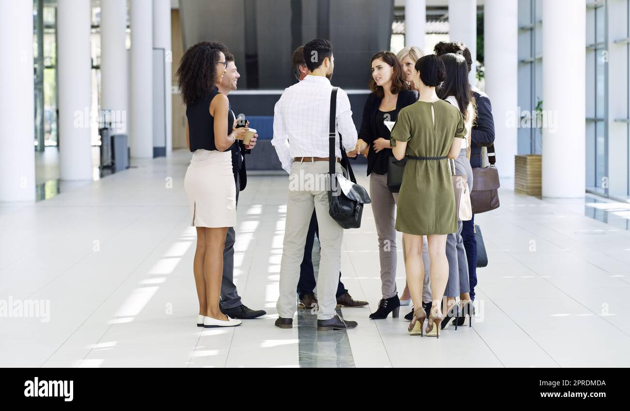 Im looking forward to getting started. Full length shot of a group of businesspeople standing in ...