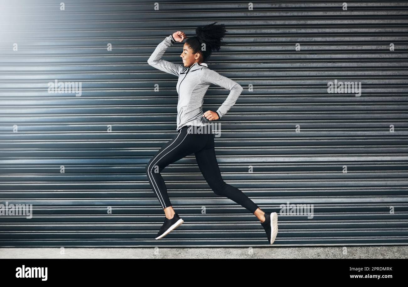 Find your fire and then run with it. a sporty young woman running ...