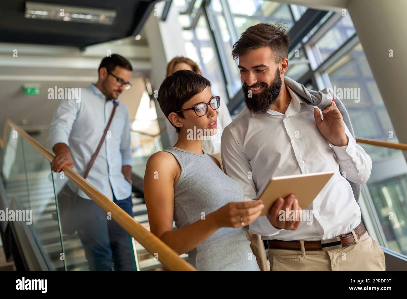 Business people having fun, teamwork and chatting at workplace office ...