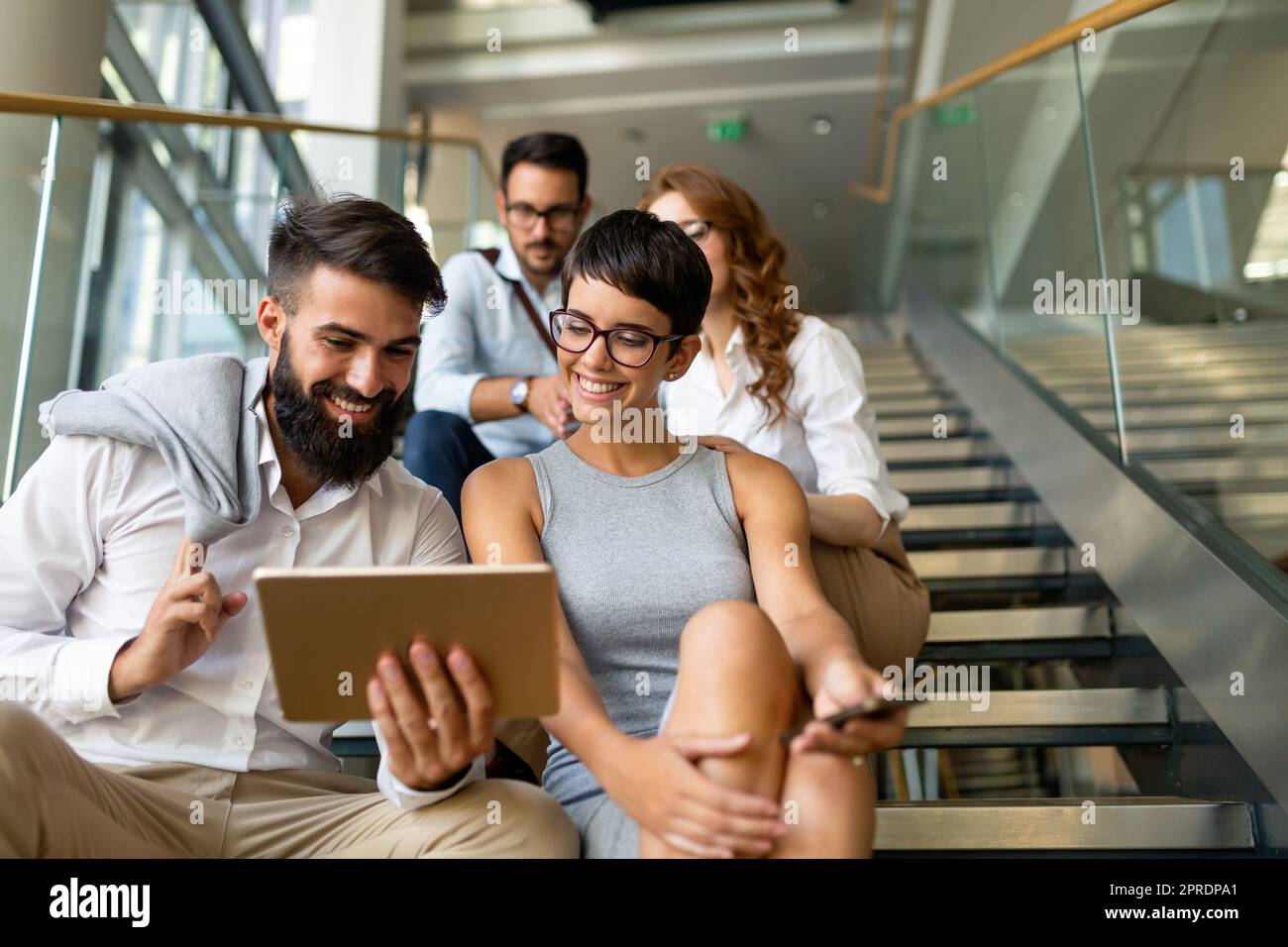 Business people having fun, teamwork and chatting at workplace office ...
