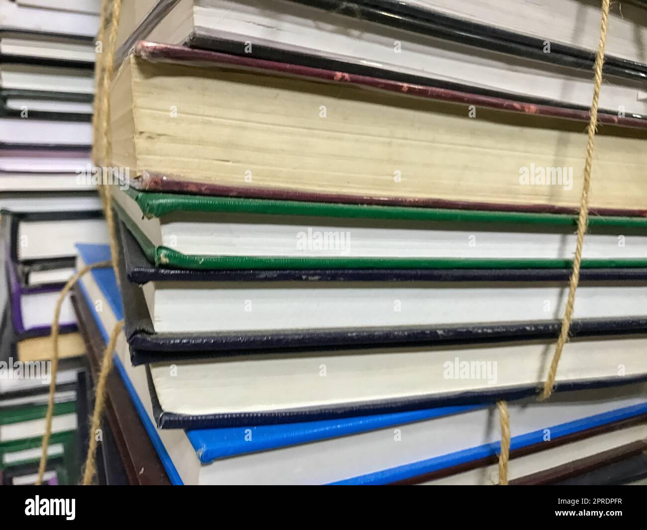 Pile of old books with rope background Stock Photo - Alamy