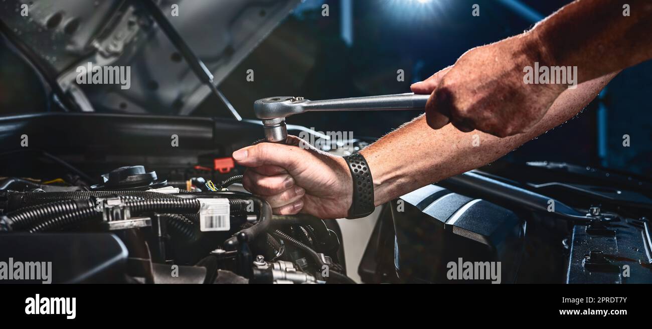 Auto mechanic working in garage. Repair service Stock Photo - Alamy